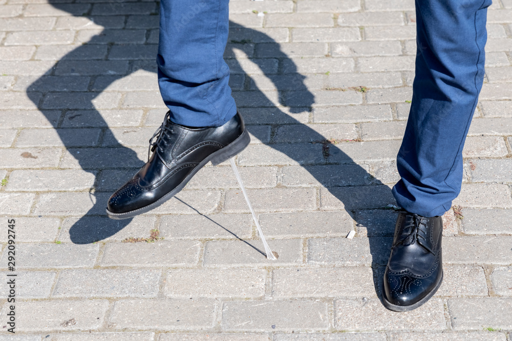Foot stuck into chewing gum on street. Concept of stickiness Stock ...