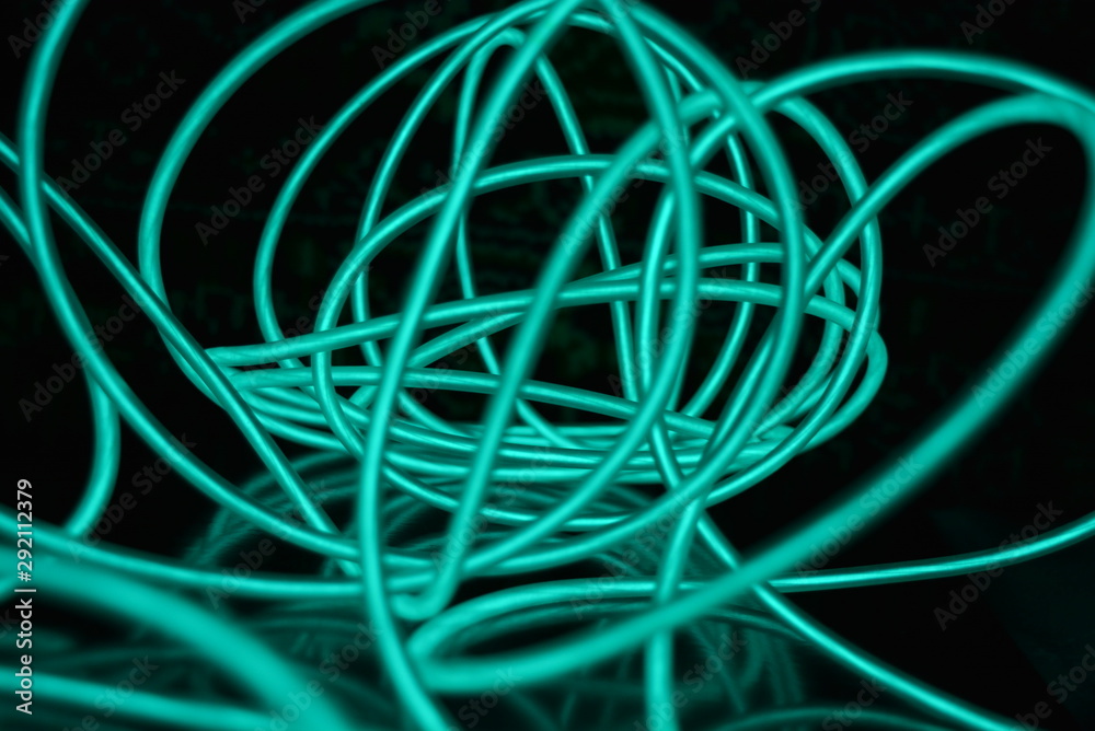 Unusual bright wires made of turquoise-colored material glowing at ...