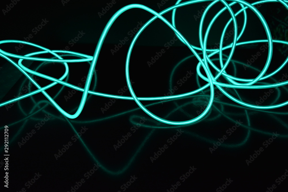 Unusual bright wires made of turquoise-colored material glowing at ...