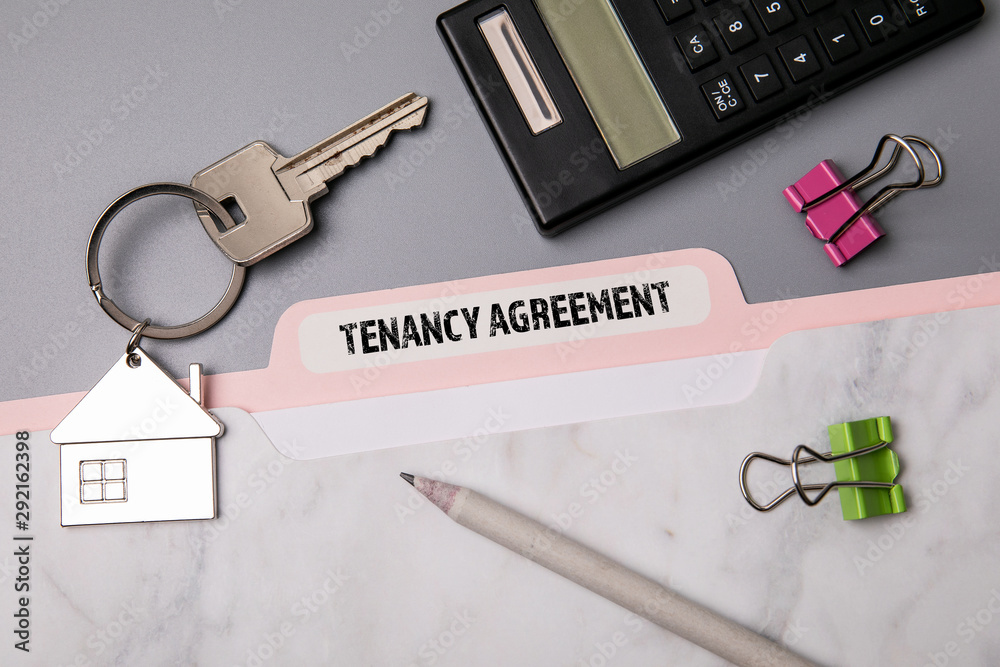 Tenancy Agreement. File folder, stationery and home keys on the office ...