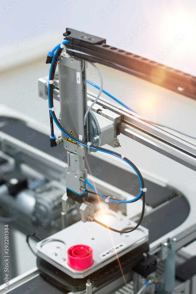 Industry 4.0 concept; artificial intelligence in smart factory. Gripper picks up the product ...