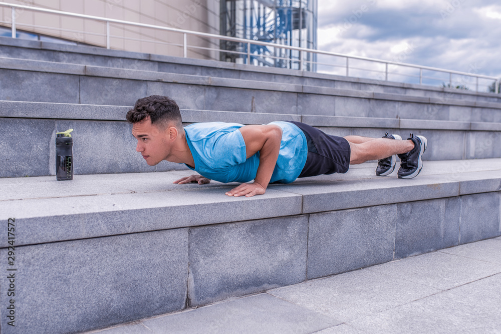 male athlete, tanned man, summer city, push-ups, lying on bench, chest ...