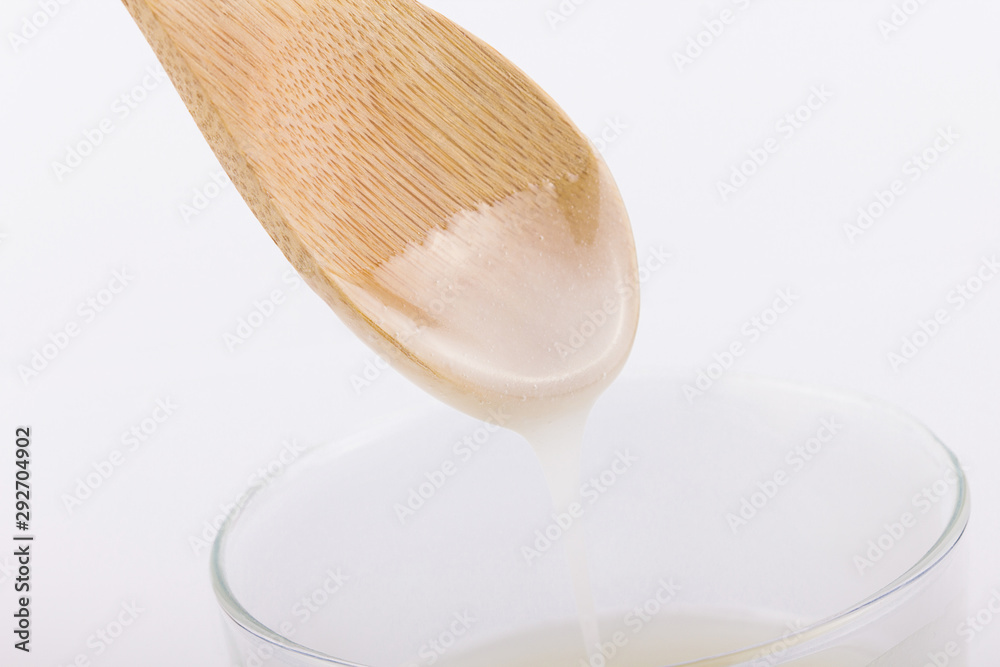 Inverted sugar syrup pouring from a spoon Stock Photo | Adobe Stock