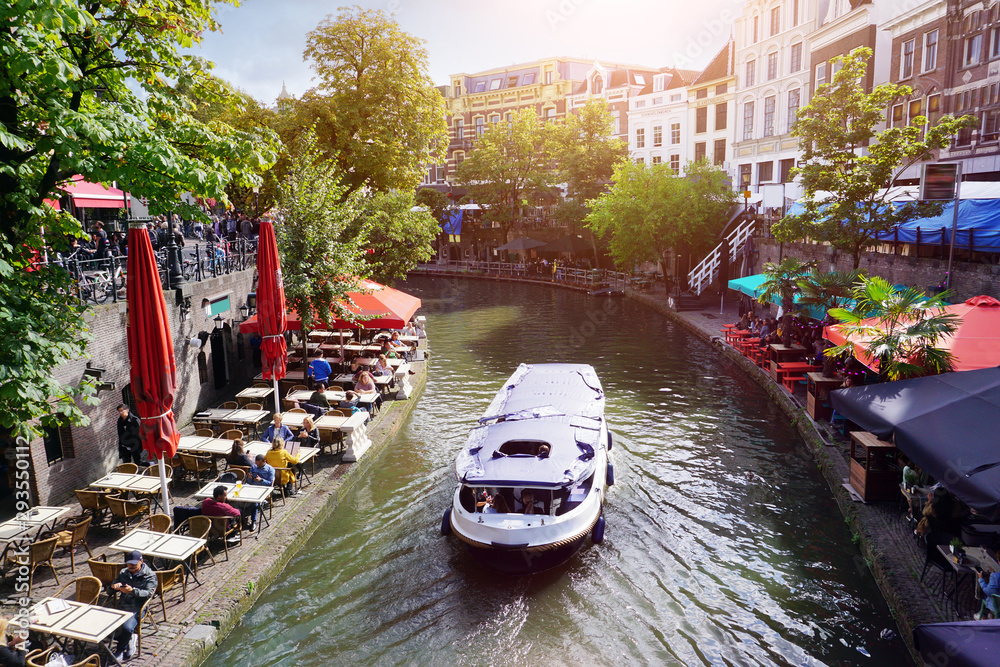 Canal Oudegracht with boat and sidewalk cafes in downtown Utrecht ...