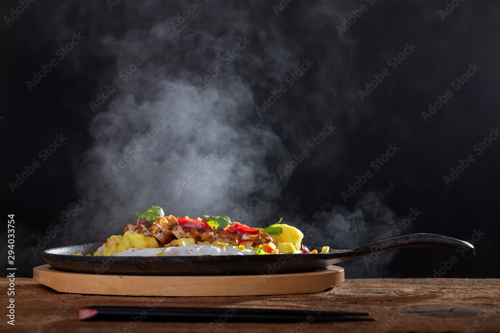 steaming hot sizzler on wood Stock Photo | Adobe Stock