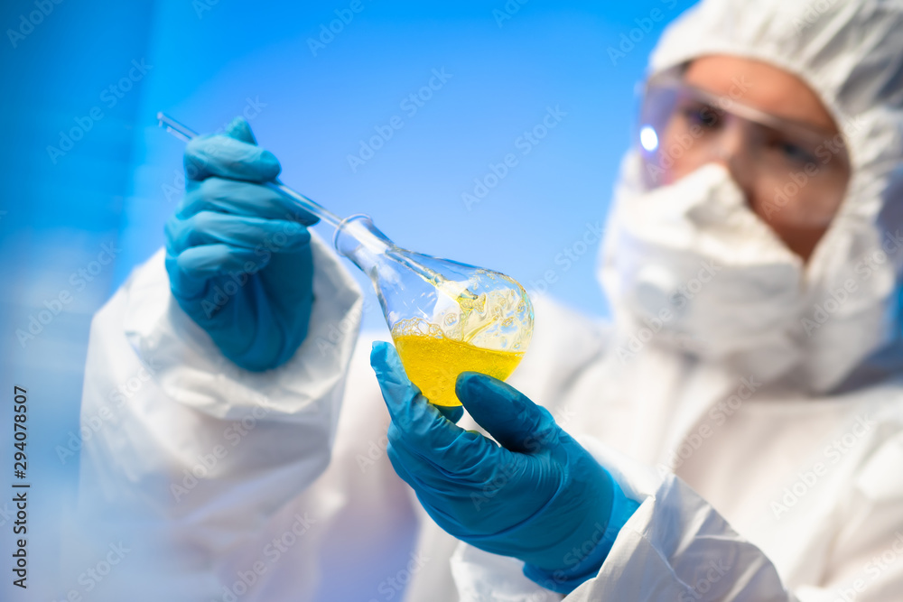 Environmental chemist studying samples from the site of pollution. An ...