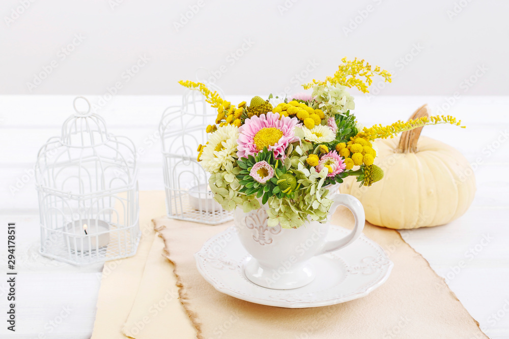 Woman shows how to make floral arrangement with summer flowers inside a ...