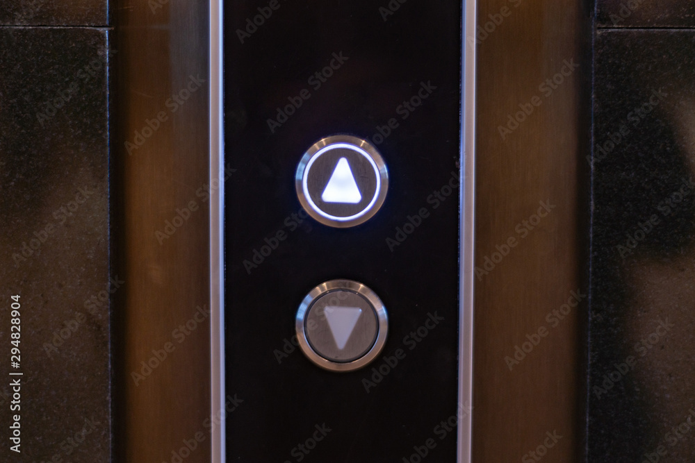 elevator call buttons on a brown wooden panel Stock Photo | Adobe Stock