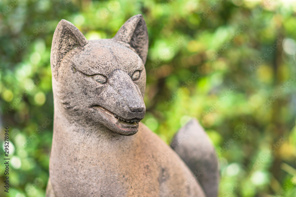 Statue of foxes inari, deity of rice in the Shinto shrine of Mejiro ...