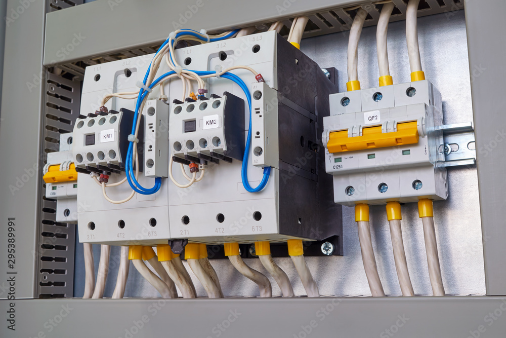 Two powerful electrical contactors or magnetic starters and two circuit ...