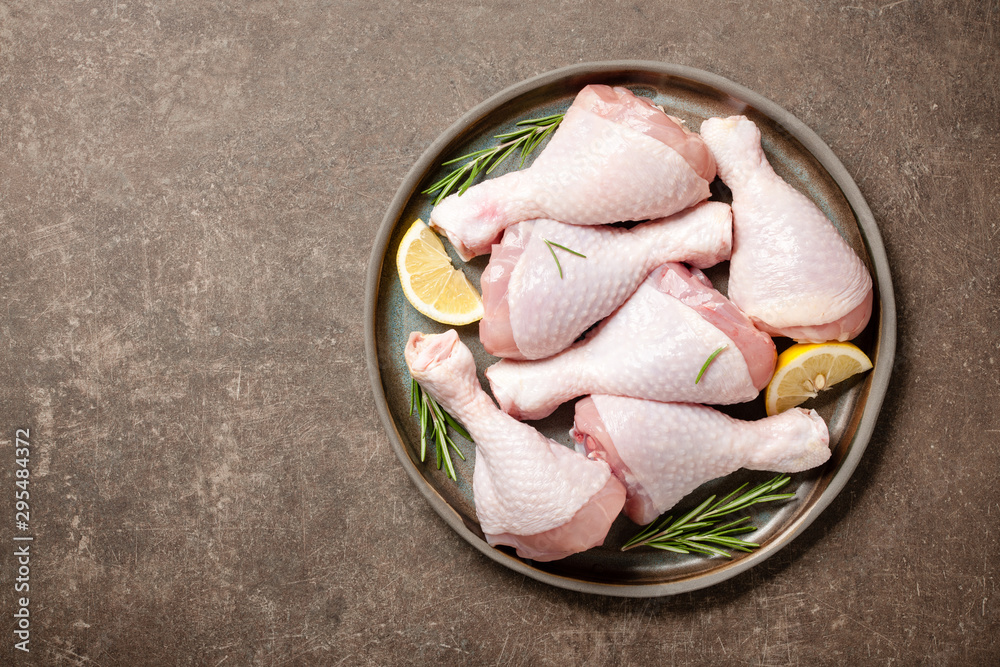 Fresh raw chicken legs with rosemary and lemon for cooking Stock Photo ...