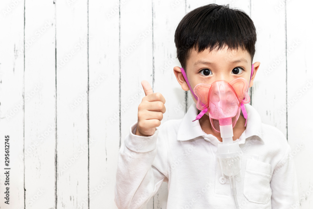 Asia boy using nebulizer and inhaler for the treatment. Little child ...