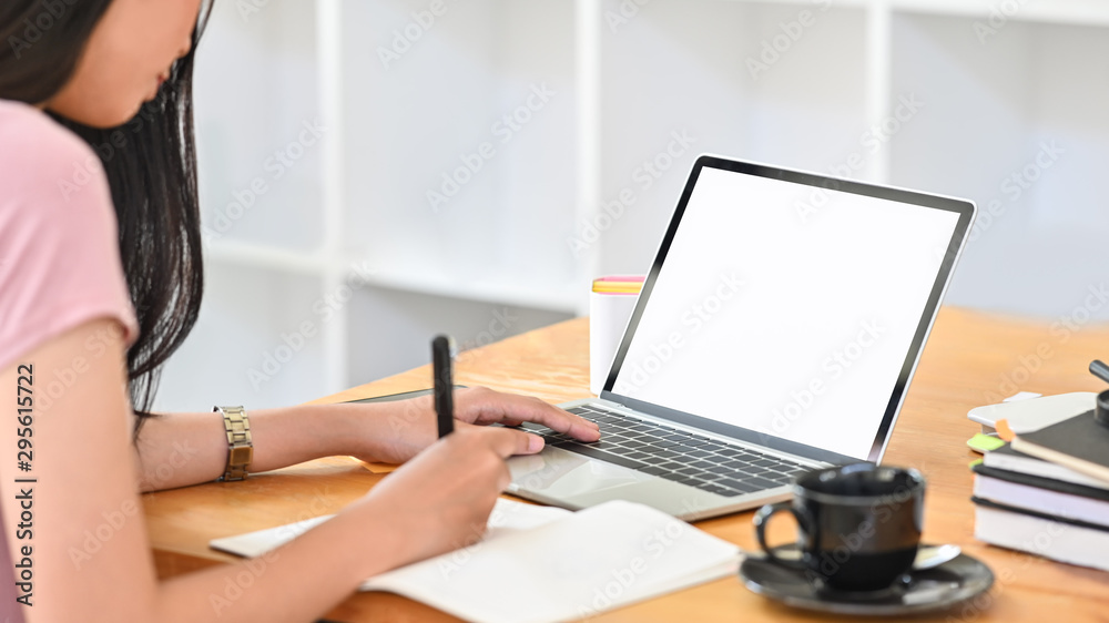 Young woman reading on note paper and using isolated white screen ...