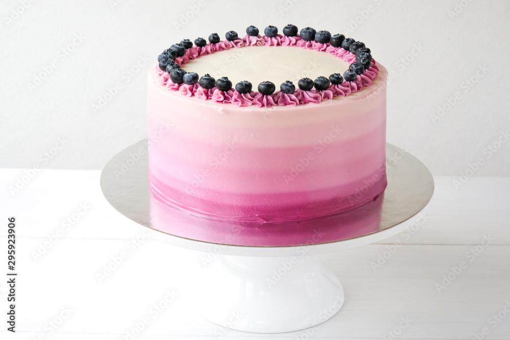 Birthday cake with blueberries and purple gradient cream on white ...