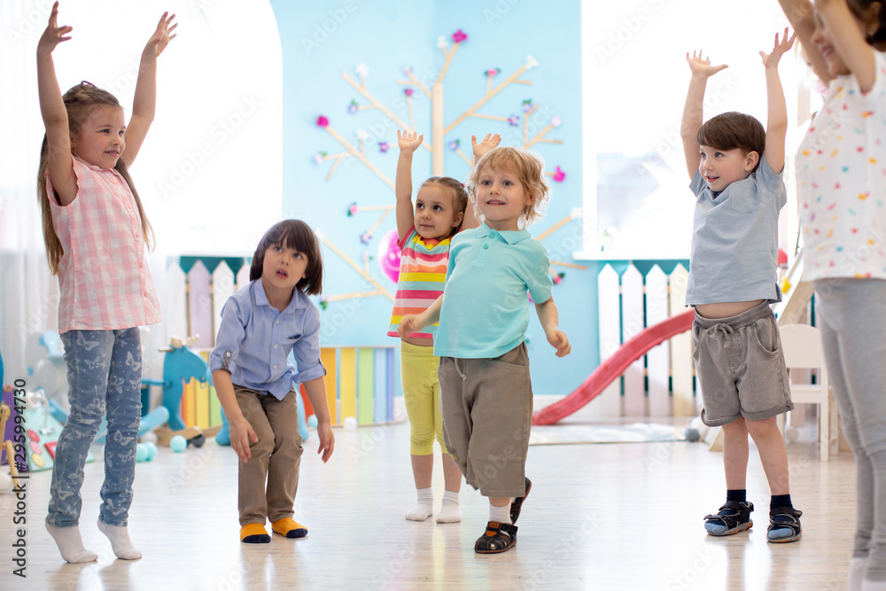Group of preschool children doing gymnastics in kindergarten. Physical ...