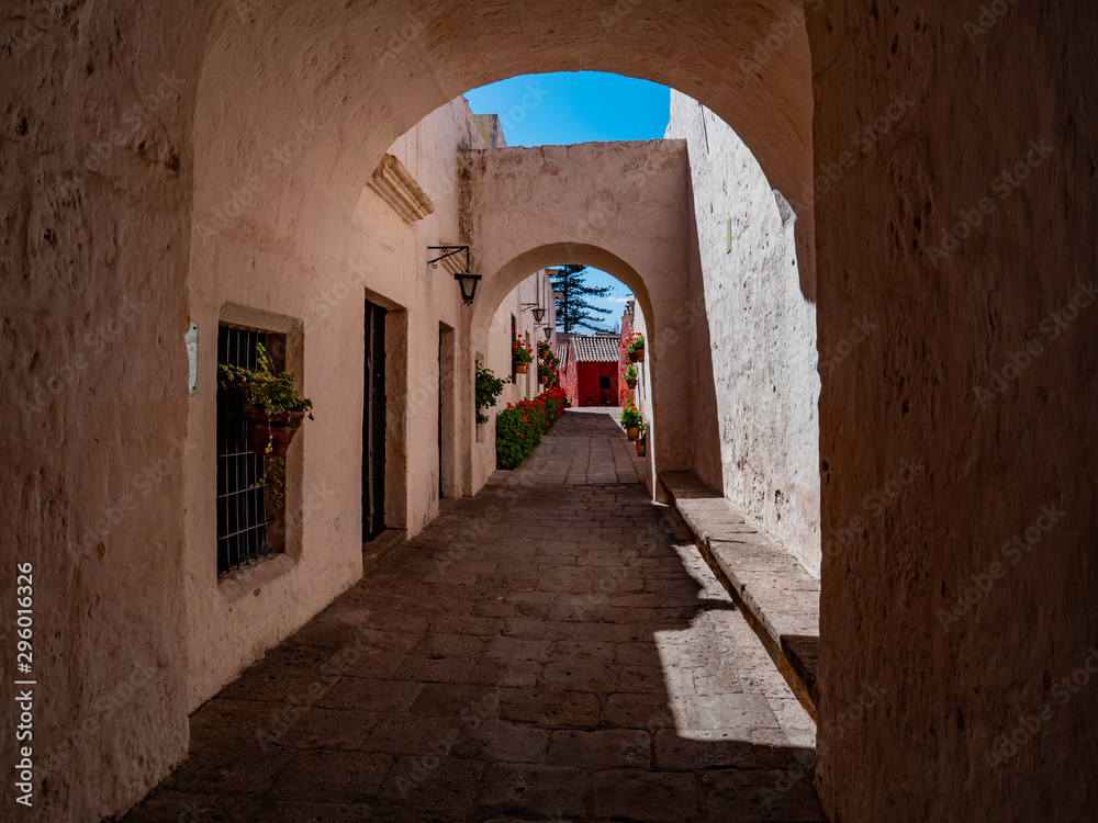 View through an arch to typical street and buildings in historic ...