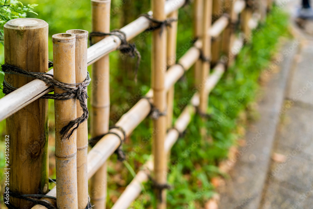 Close up rustic bamboo fence along Japanese Garden and street in Park ...
