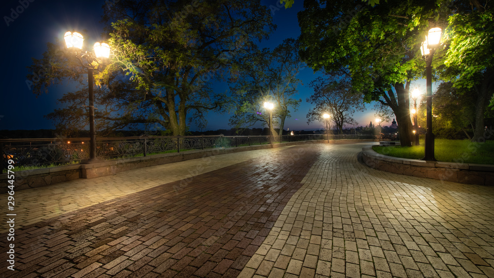 Empty city park landscape at the late evening or night with lit ...