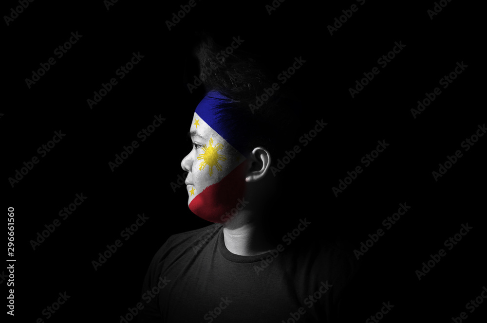 Dramatic scene of a Filipino young man face painted in Philippine flag ...