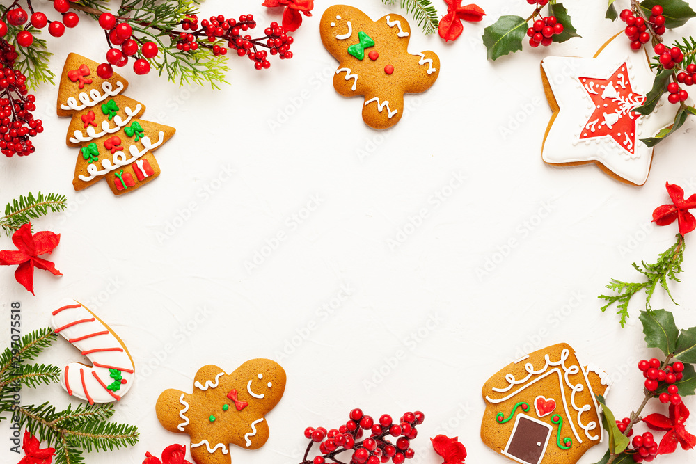 Christmas background with gingerbread cookies and branches of holly ...