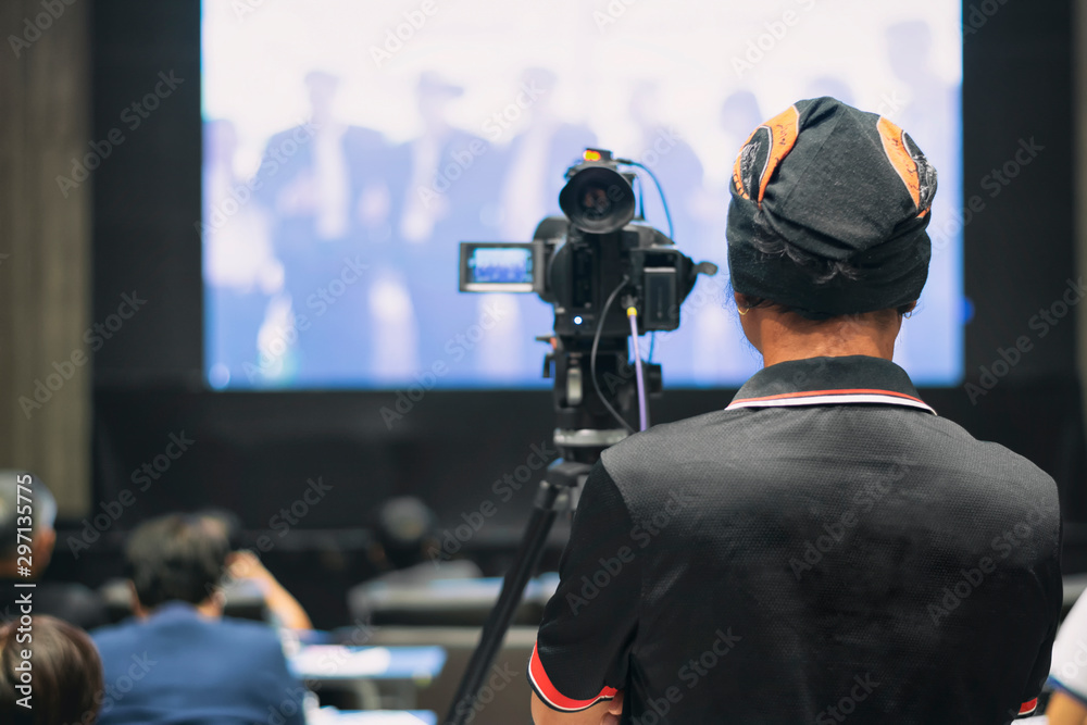 Recording video camera operator professional cameraman working with his ...