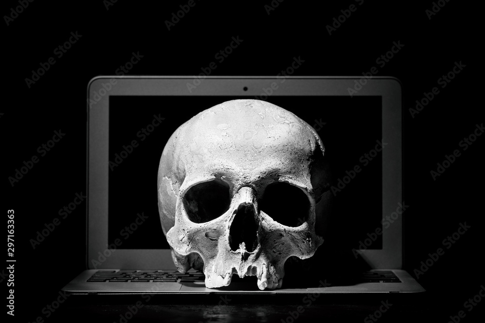 Cybercrime or hacking concept. Laptop in dark room under beam of light ...