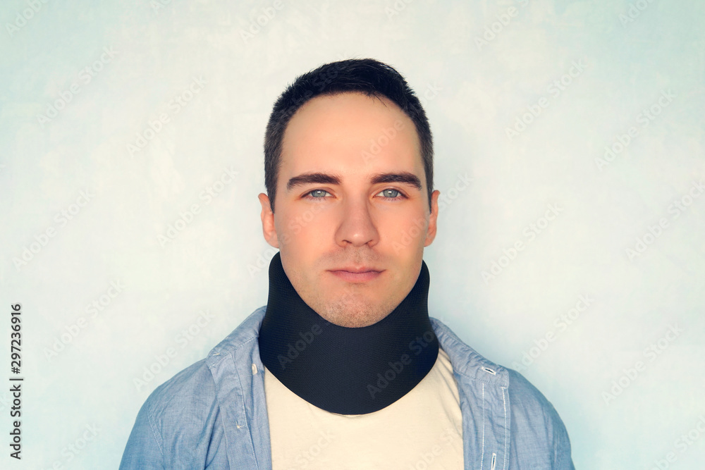 Man with neck brace after whiplash injury blue background, black neck ...