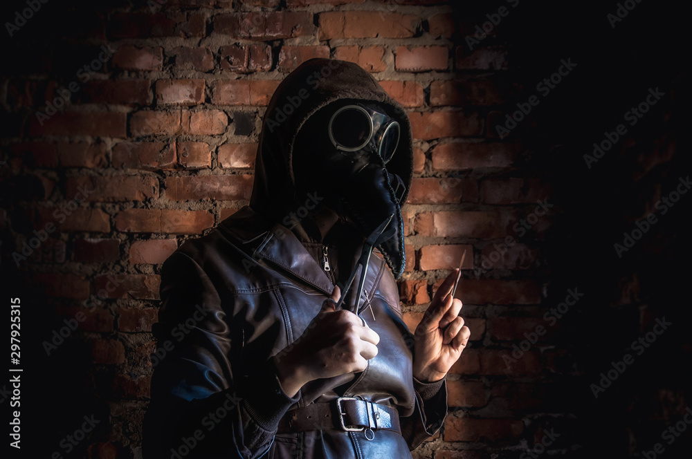 Terrible plague doctor on red brick background. Masked maniac with ...
