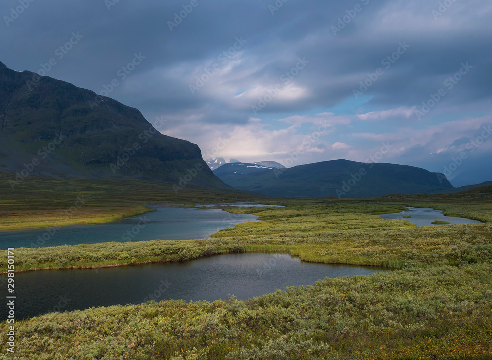 Beautiful wild Lapland nature landscape with blue glacial river, birch ...