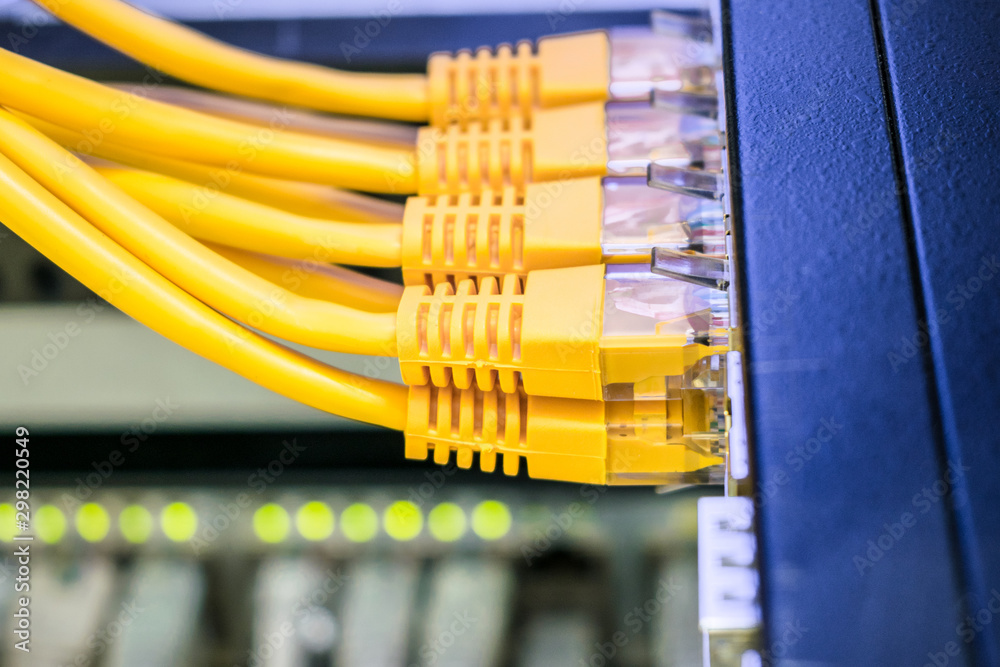 Internet cable is in the datacenter server room. Several yellow network ...