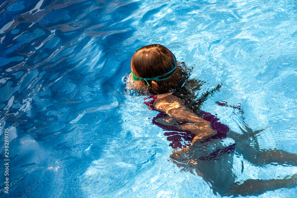 Healthy lifestyle. Young swimmer training in transparent blue water ...