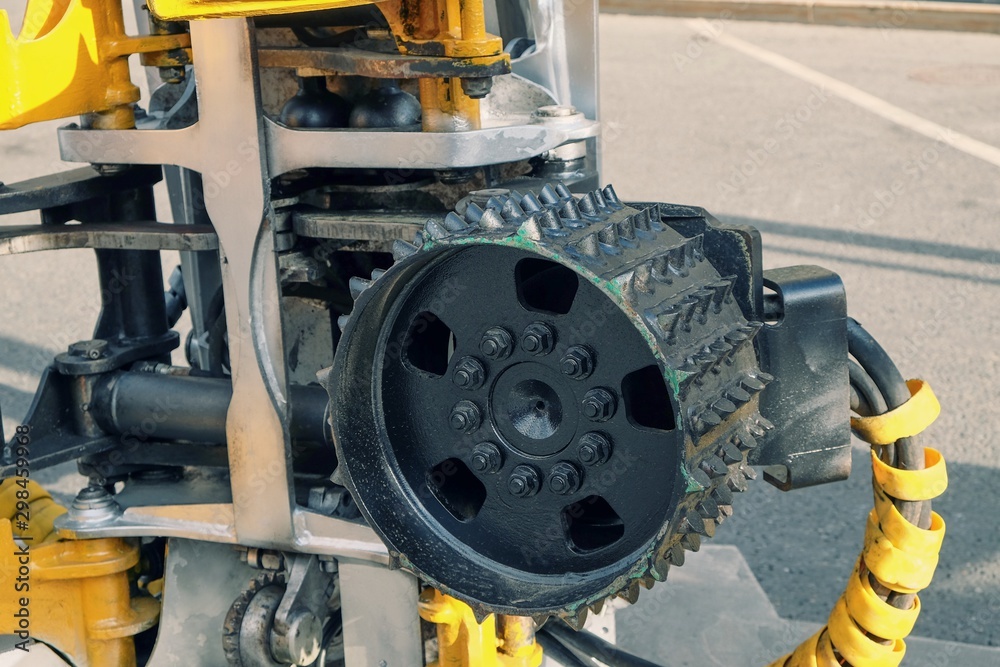 Cog furface of harvester head closeup as a part of gripping unit ...