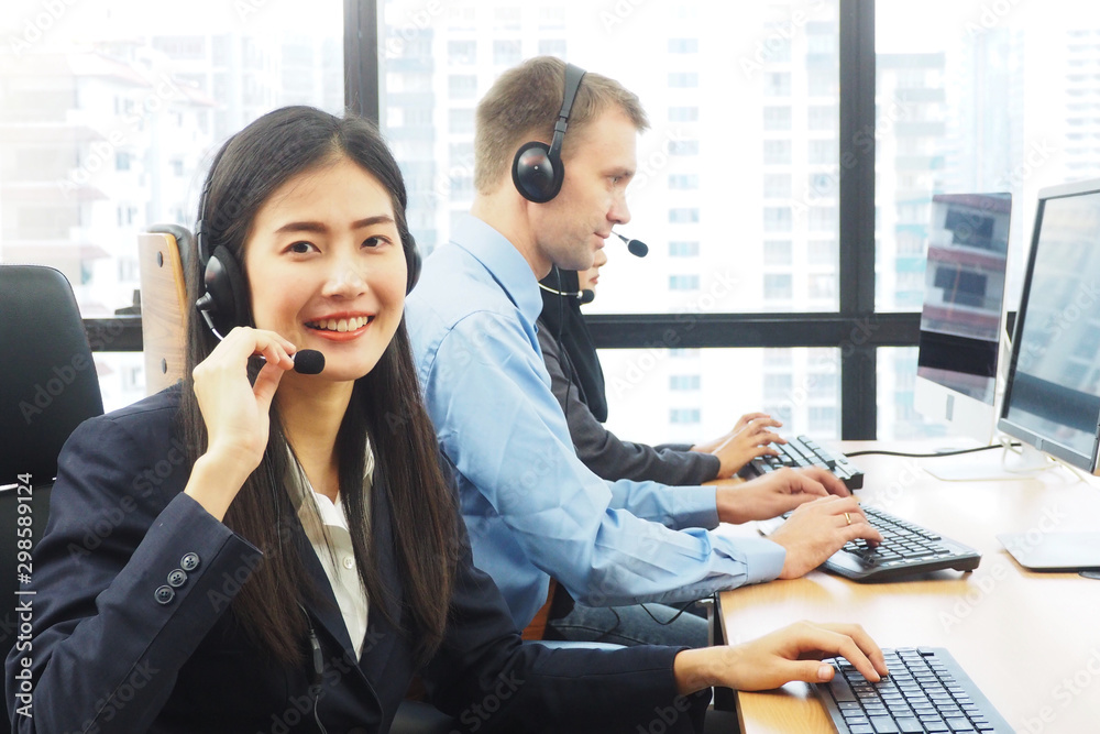 Active Asian woman and her multicultural colleagues smiling and feeling ...