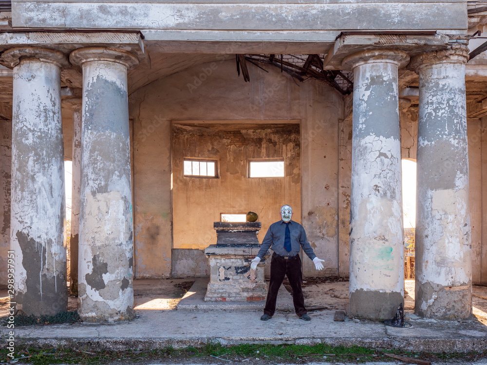 man in ghost costume with gold mask skeleton. Halloween at cult site of ...
