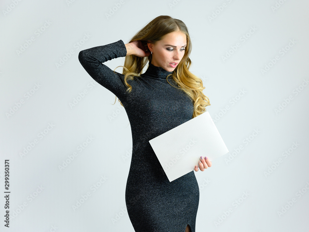 Portrait of a pretty blonde secretary girl with long curly hair in a ...