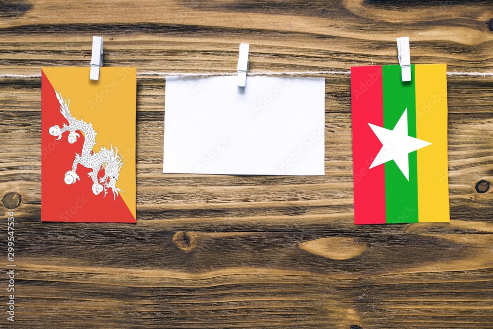 Hanging flags of Bhutan and Myanmar attached to rope with clothes pins ...