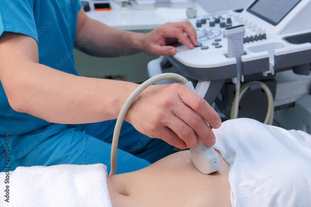 Ultrasound diagnostic of stomach on abdominal to woman in clinic ...