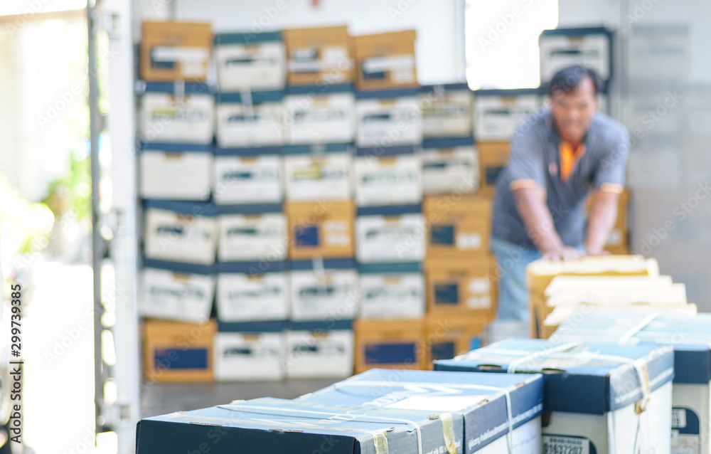 Blur white An employee loaded a cardboard box into a truck. Deliverymen ...