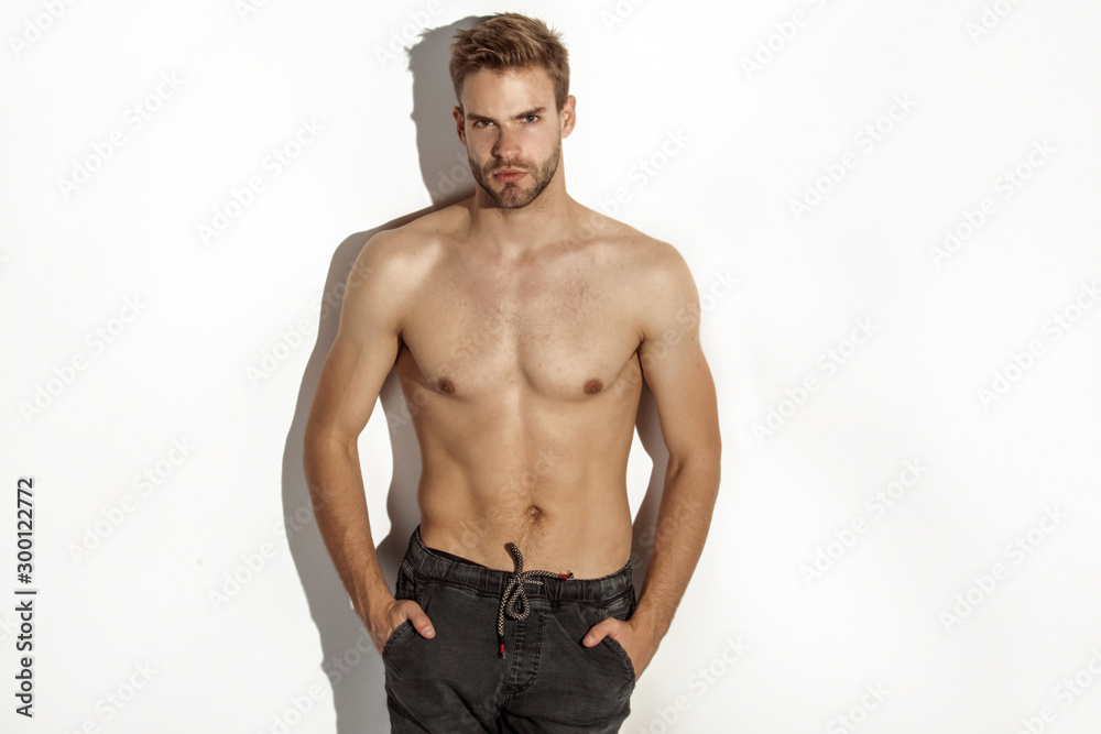 Muscle strong beautiful stripped male model in denim jeans on white ...