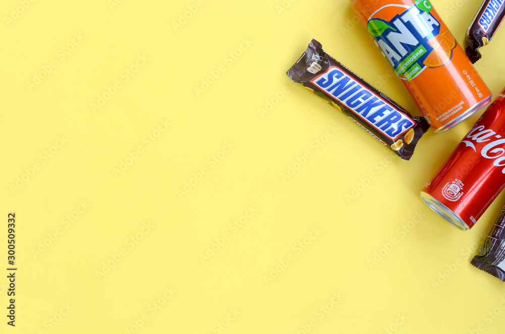 Snickers chocolate bar in brown wrapping lies with red Coca Cola and ...