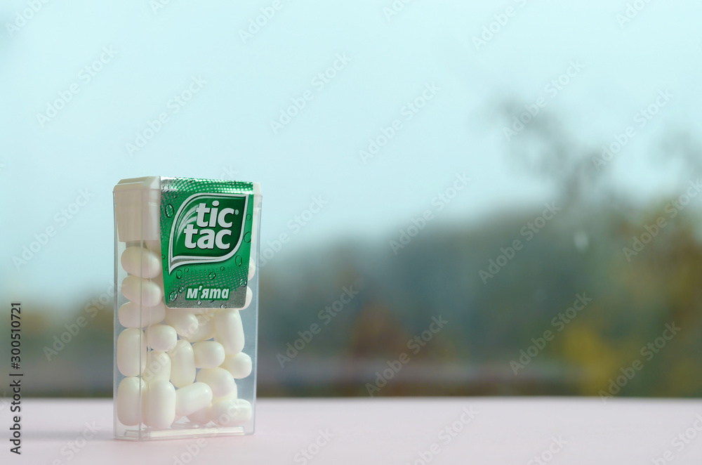 Many Tic Tac Candy packages on green wood background. Tic tac is ...