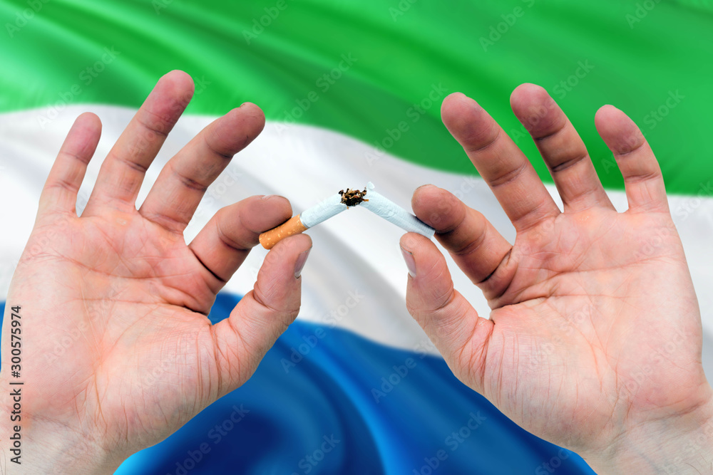Sierra Leone quit smoking cigarettes concept. Adult man hands breaking ...