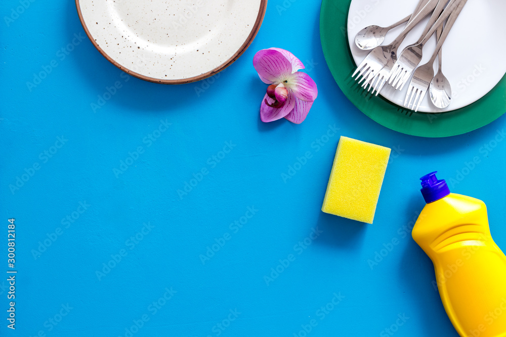 Washing dishes frame with plates, sponges, dishwashing liquid on blue ...