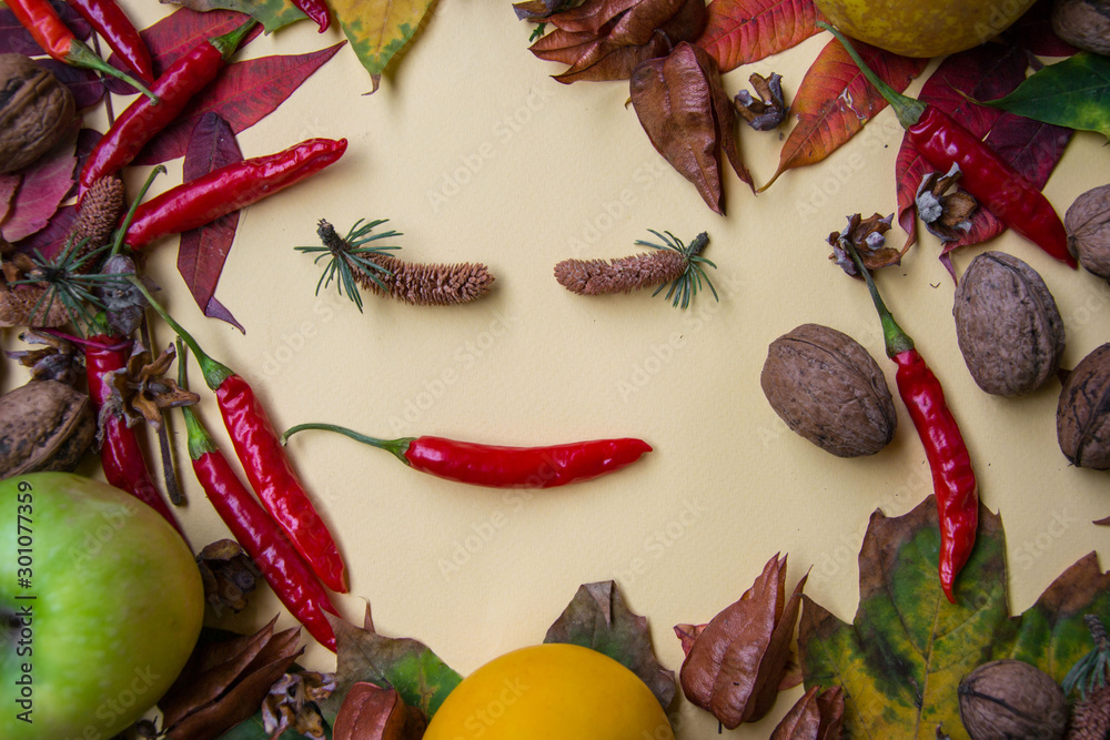 Bunch of colorful leaves, pods, food and nuts on yellow background ...