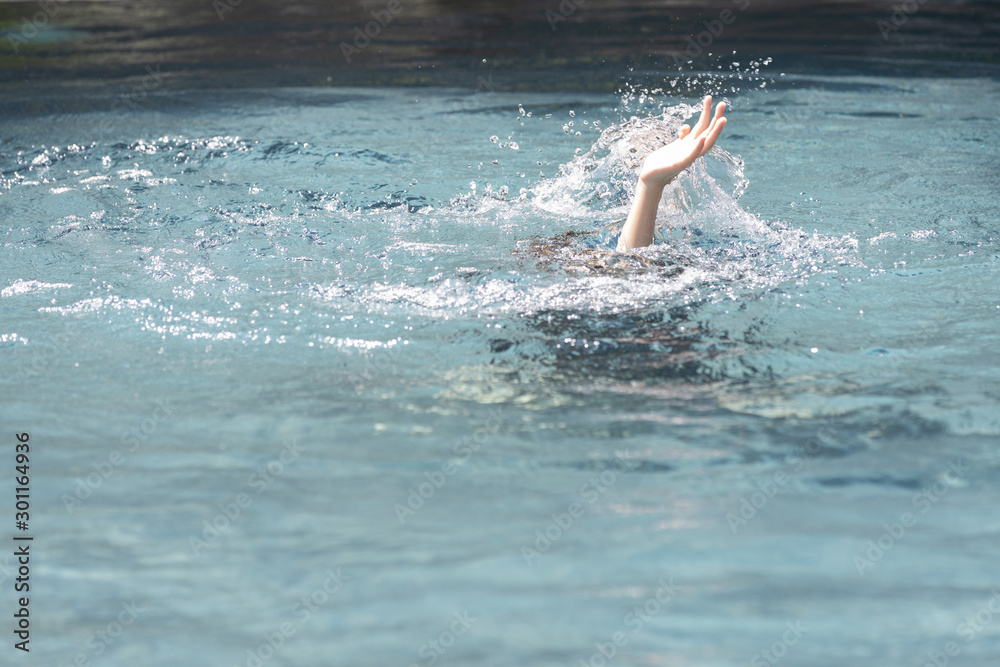 Asian child girl struggling underwater, hand peeking out of the water ...