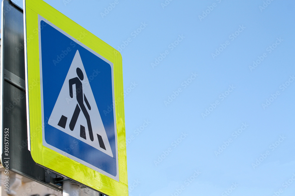 Pedestrian crossing blue sign with yellow light-reflecting frame. Blue ...