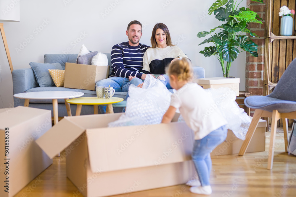 Beautiful family, parents sitting on the sofa drinking coffee looking ...