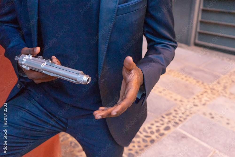 Bandit black guy threatening with a gun to rob. Elegance african ...