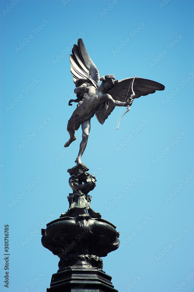 Statue of Anteros (brother of the Greek god Eros) standing in sunny ...