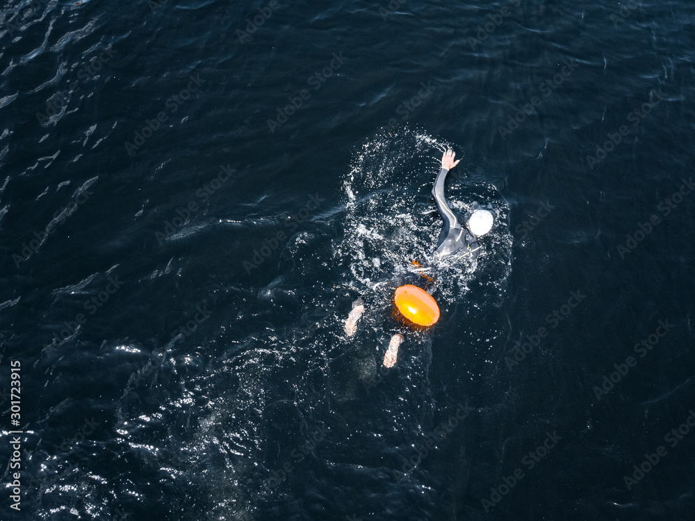 Arctic people swim ice hole in cold water, athletes in wetsuits with ...